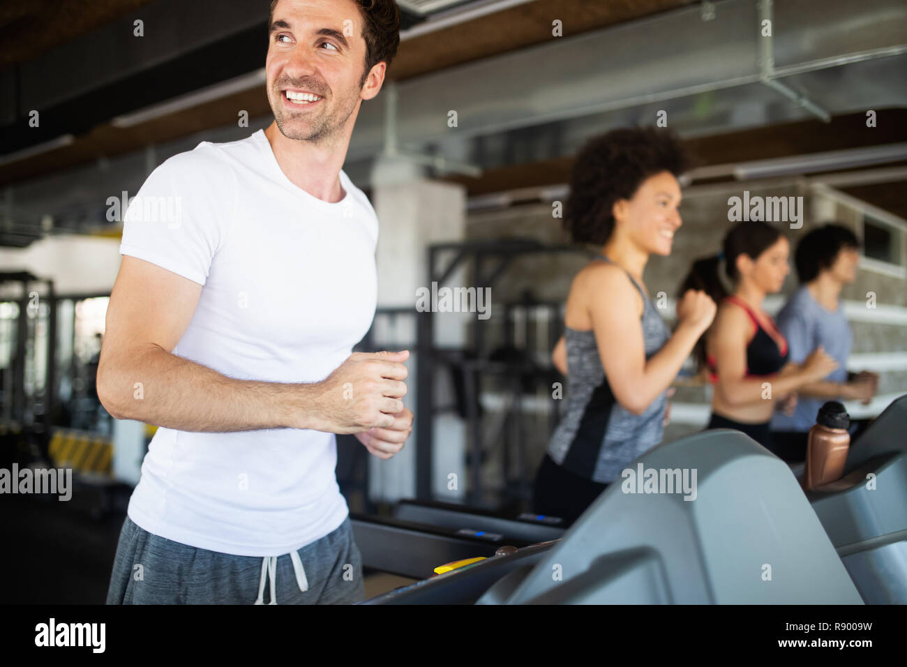 Happy gorup of healthy people training in gym Stock Photo - Alamy