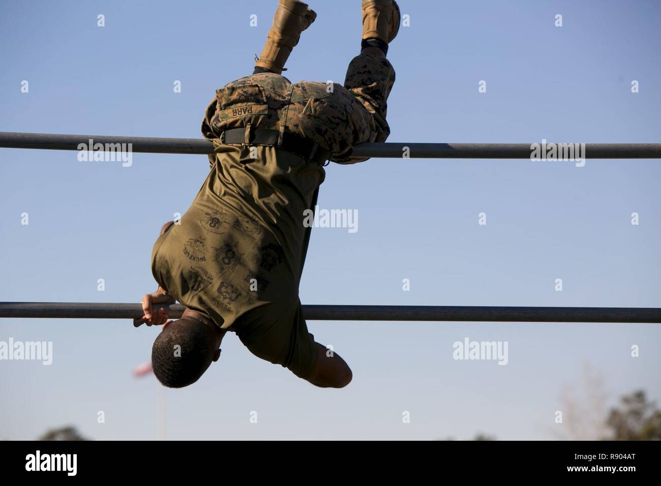 A Marine clears an obstacle during the obstacle course portion of the ...
