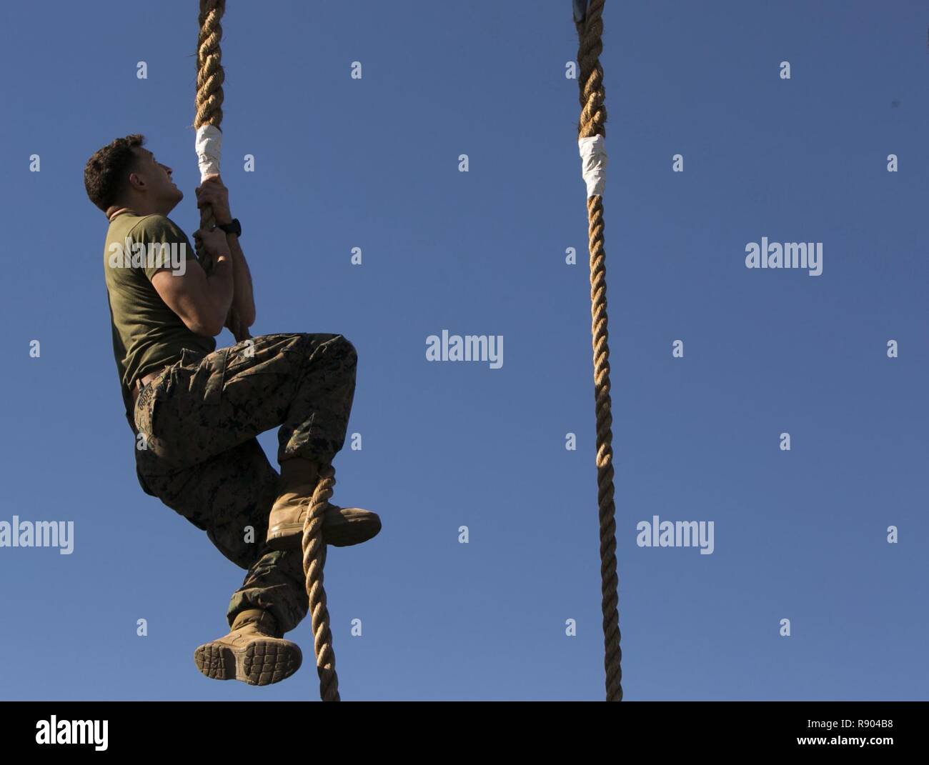 A Marine clears an obstacle during the obstacle course portion of the ...