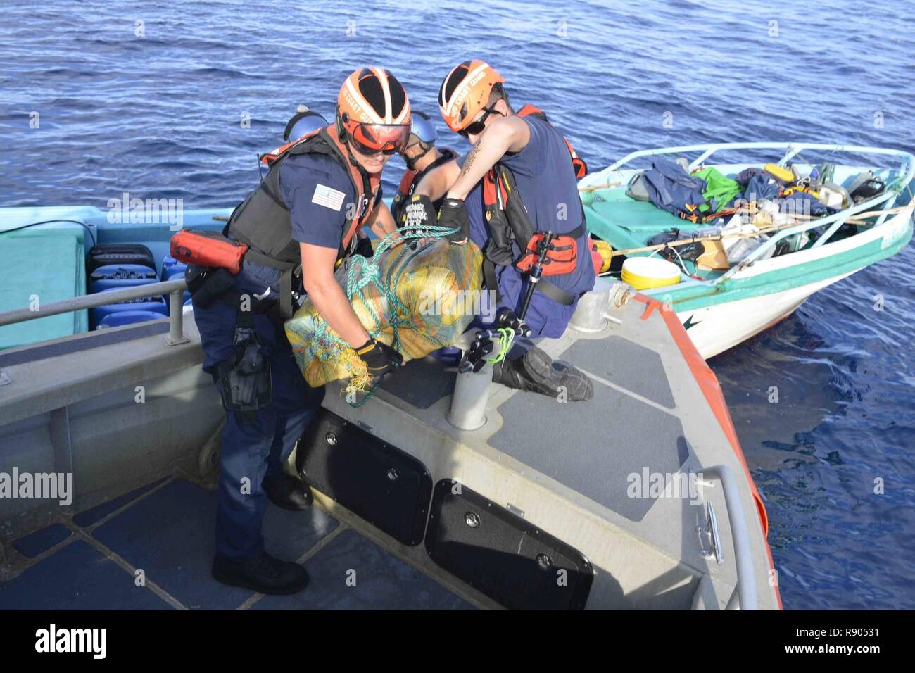 Boarding officers in an interceptor boat from the U.S. Coast Guard ...