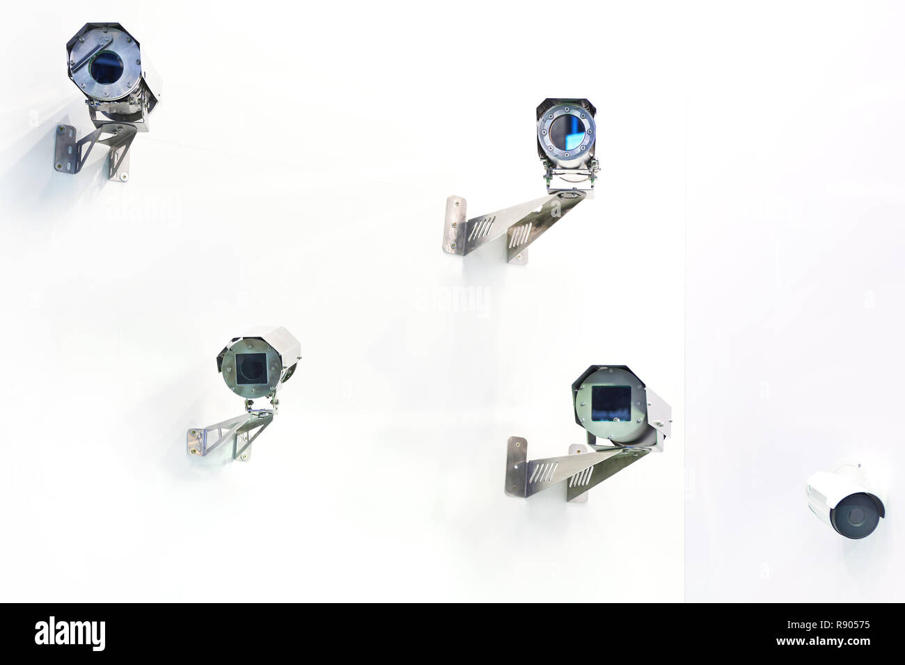 Surveillance cameras on white wall Stock Photo - Alamy