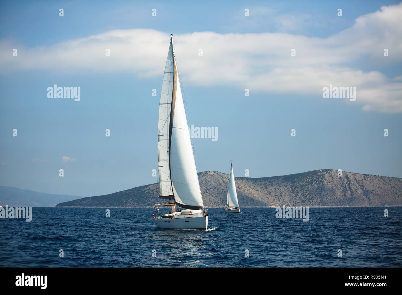 Sailing luxury yacht boats glide on the water surface of the Aegean Sea ...