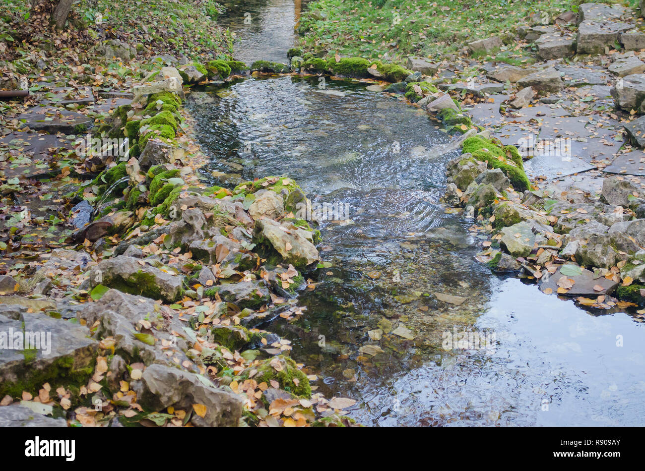 Source of drinking water, surrounded by old stones Stock Photo - Alamy