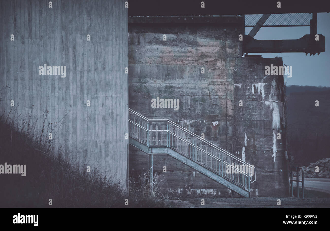 Pedestrian sidewalk stairs beside a big stone wall Stock Photo - Alamy