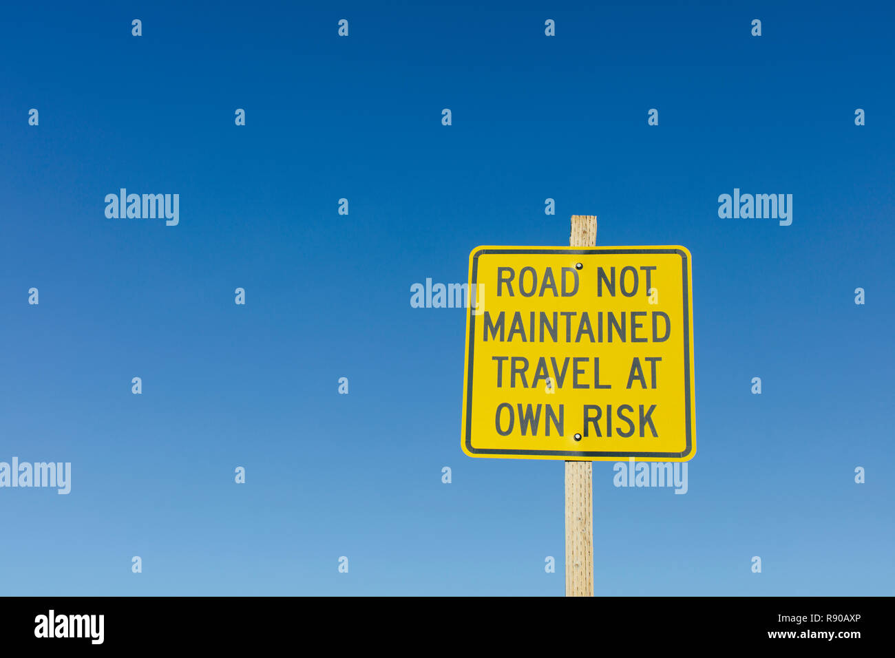 Road Not Maintained Travel at Own Risk sign along remote desert road ...