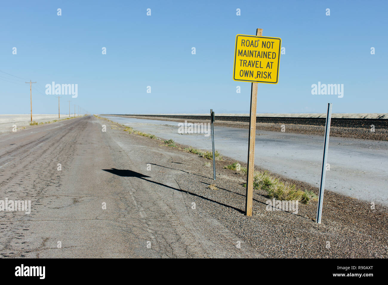 Road Not Maintained Travel at Own Risk sign along remote desert road ...