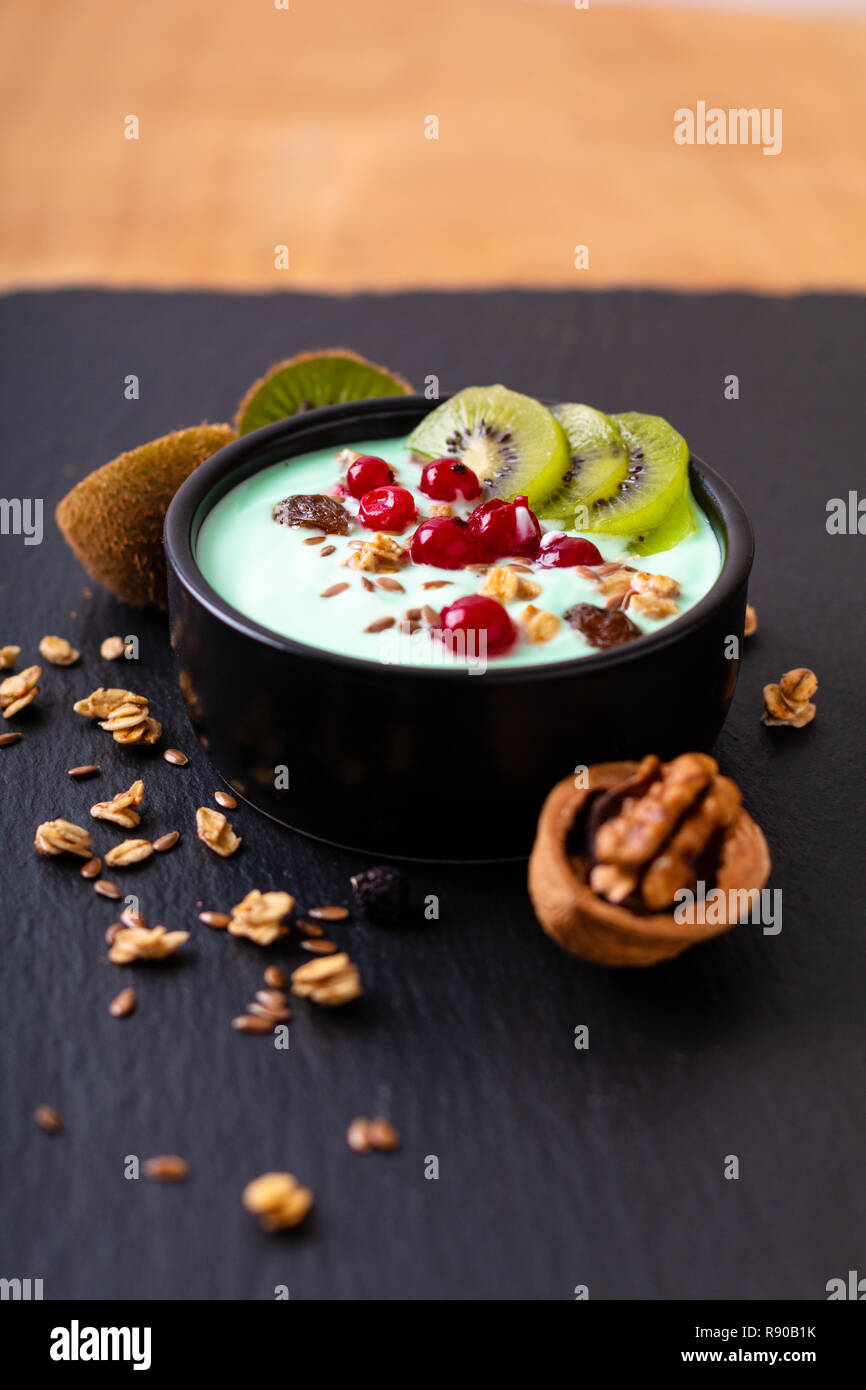 Healthy food colorful Yogurt Breakfast Bowl with kiwi, flax seeds ...
