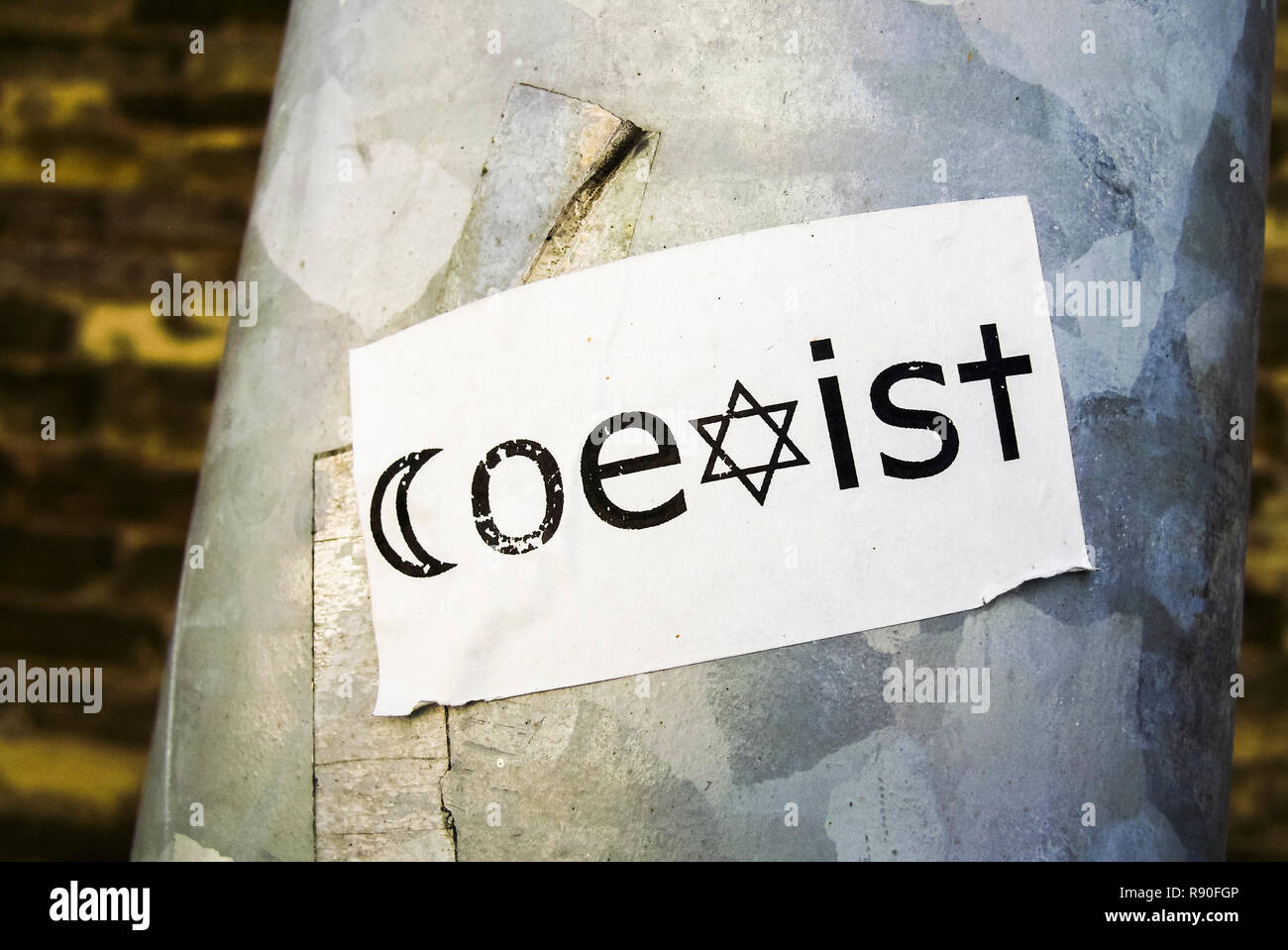 sticker saying "coexist" using the star of david and the crescent as "c ...