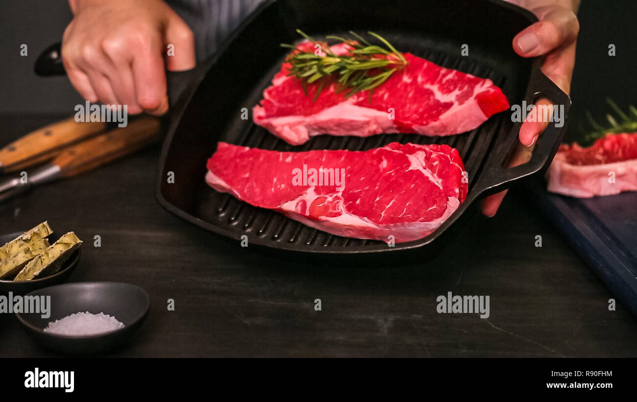 Raw steaks in cast iron hi-res stock photography and images - Alamy