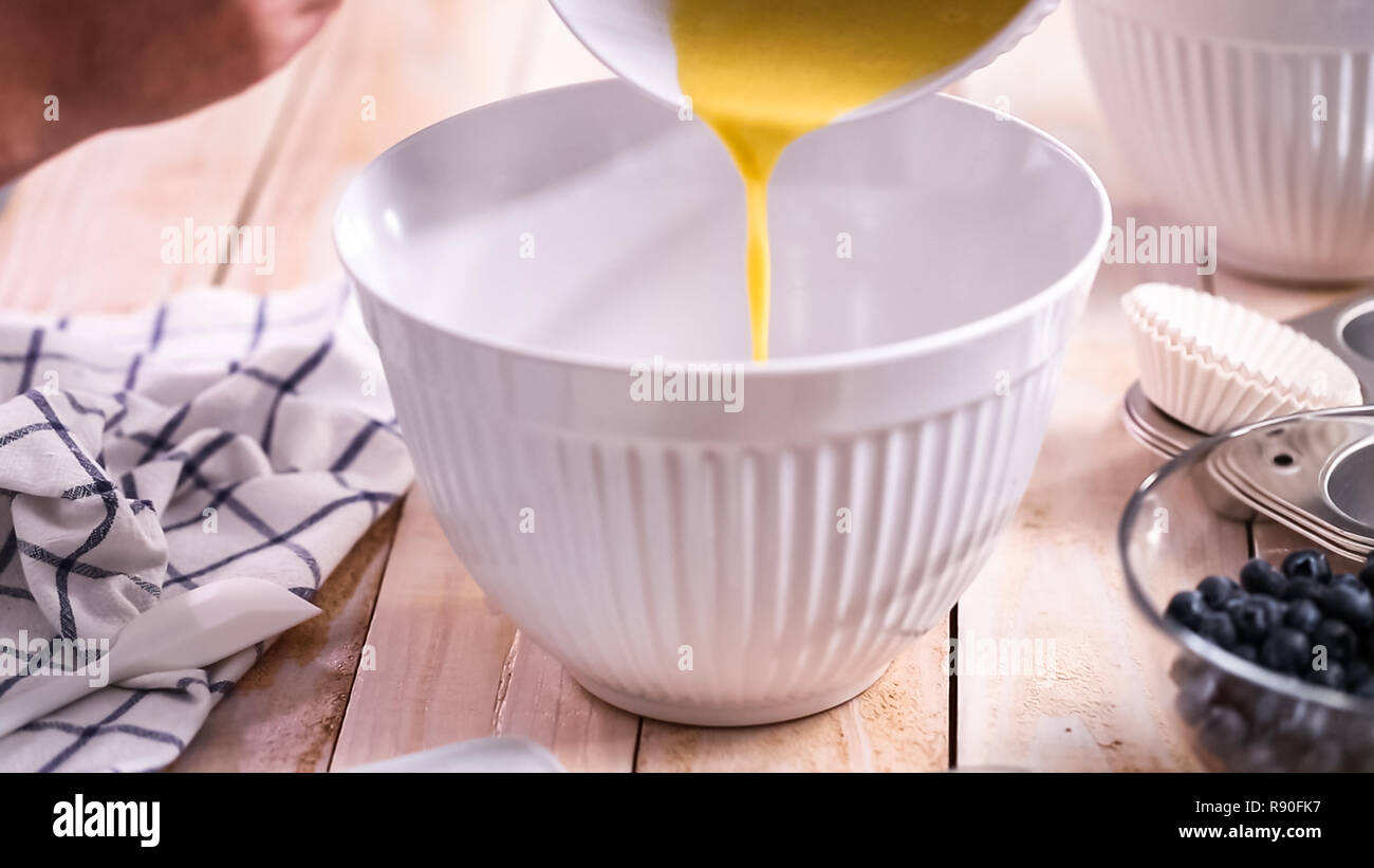 Mixing ingredients together in mixing bowl for blueberry muffins Stock ...