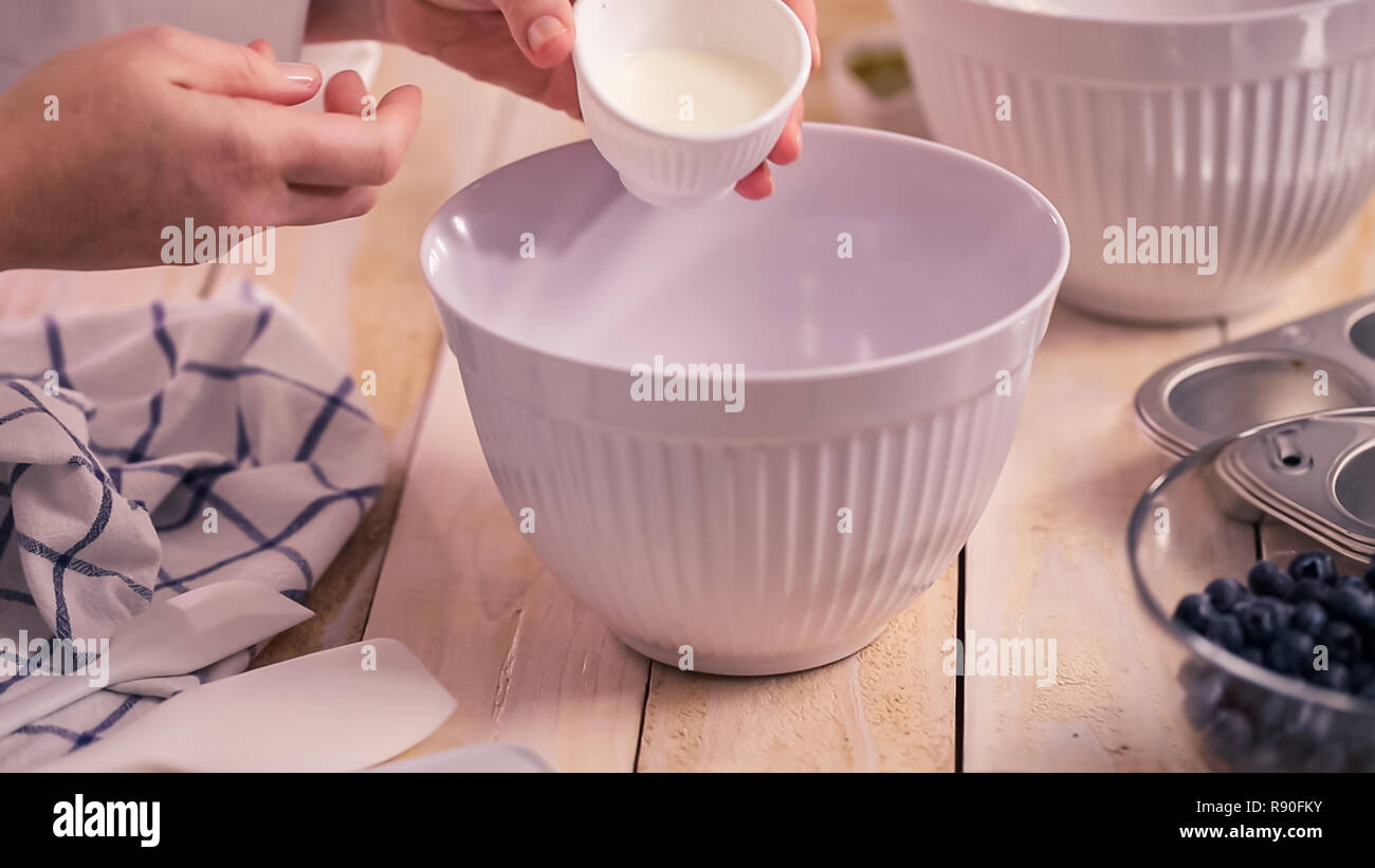Mixing ingredients together in mixing bowl for blueberry muffins Stock ...