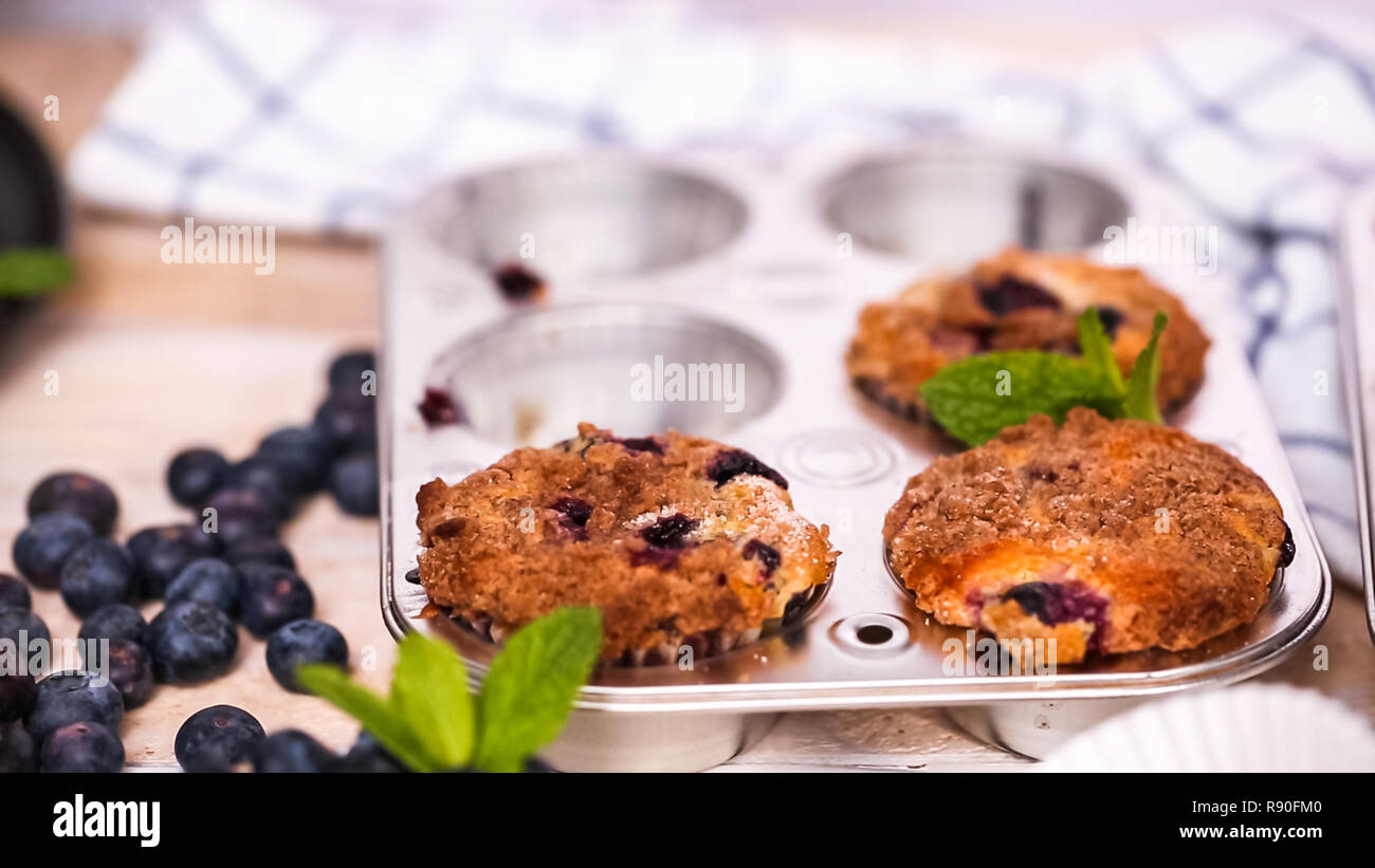 Taking blueberry muffins out of metal muffin pan Stock Photo - Alamy