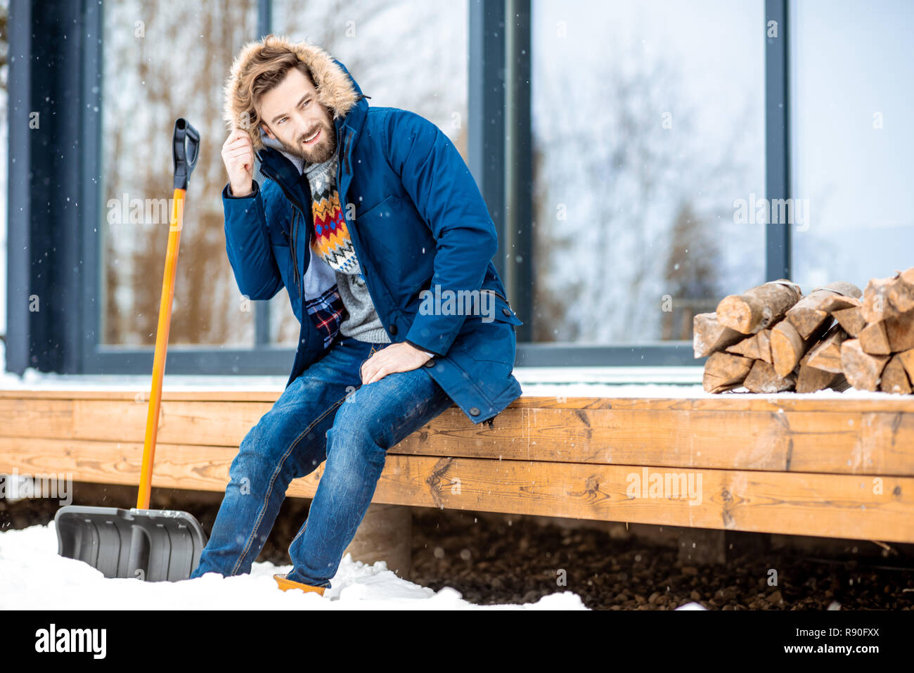 Portrait of a handsome man in winter clothes filling cold sitting on ...