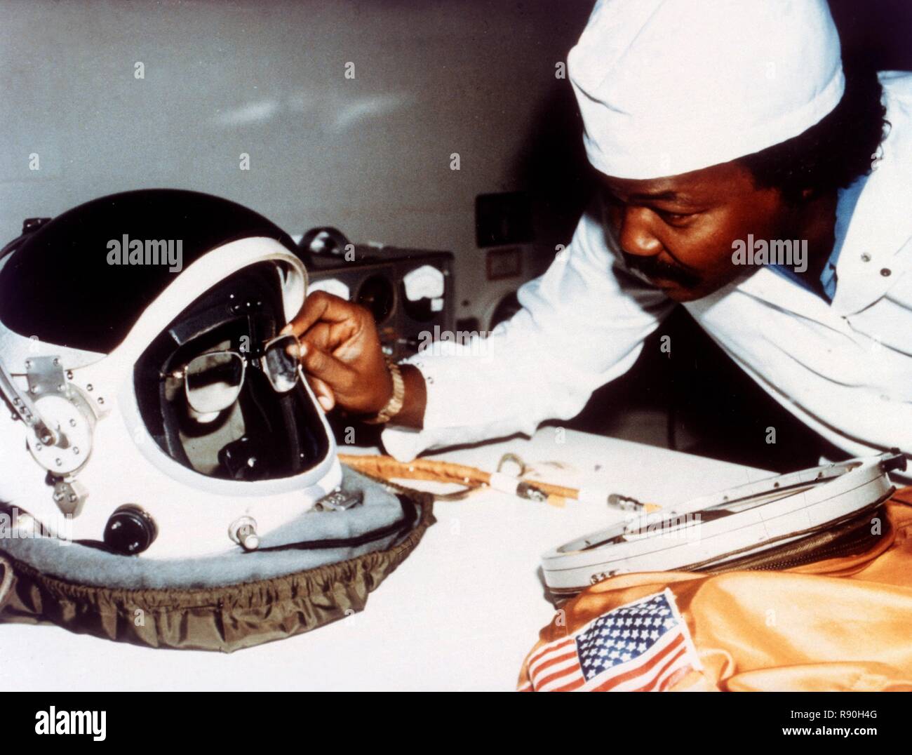 Technician installing eye-glasses in helmet. Creator: NASA Stock Photo ...