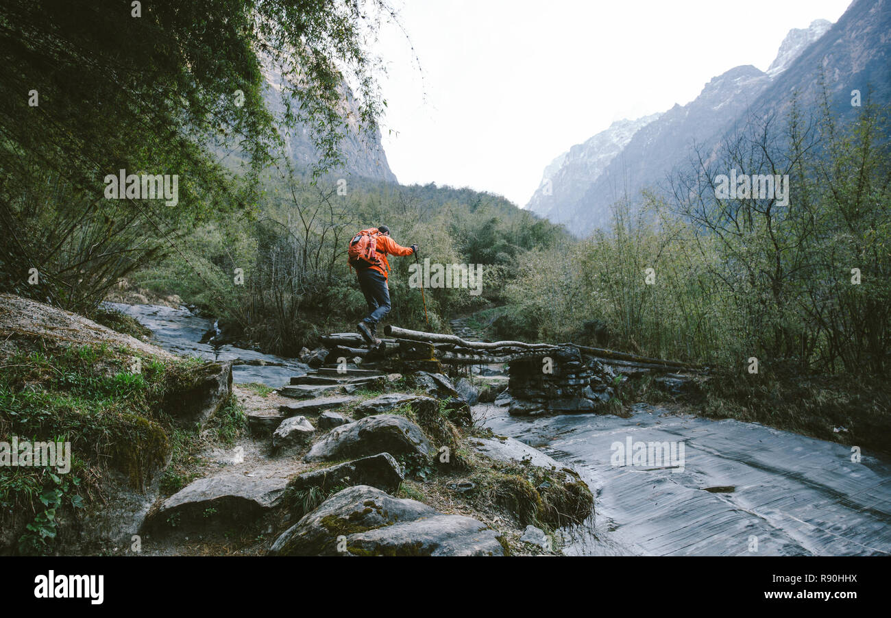 Single hiker crossing the mountain bridge Stock Photo - Alamy