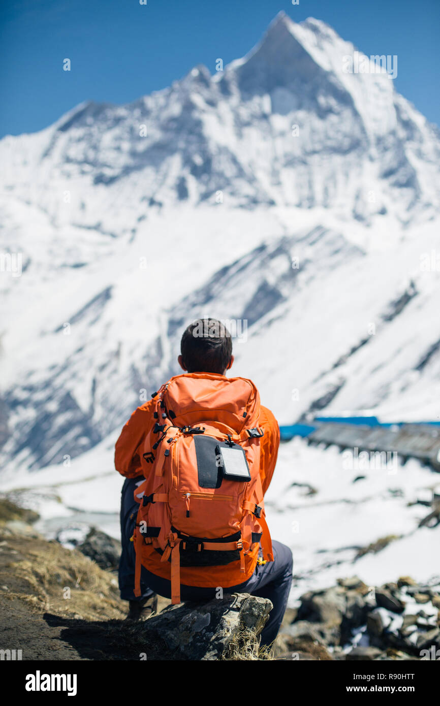 The mountains are calling. Mountaineer looking at the top of one of ...