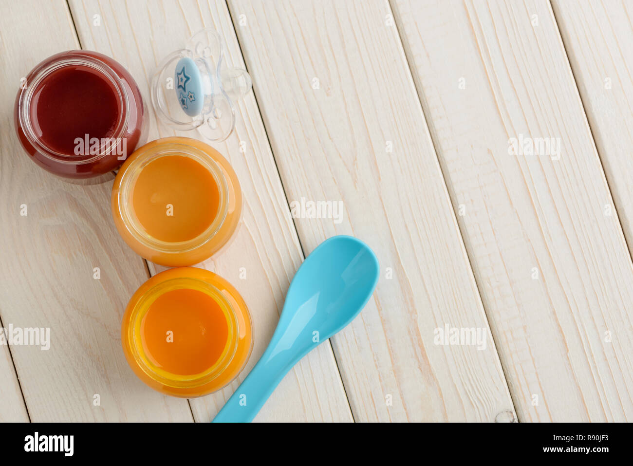 Baby food, pacifier and spoon Stock Photo - Alamy