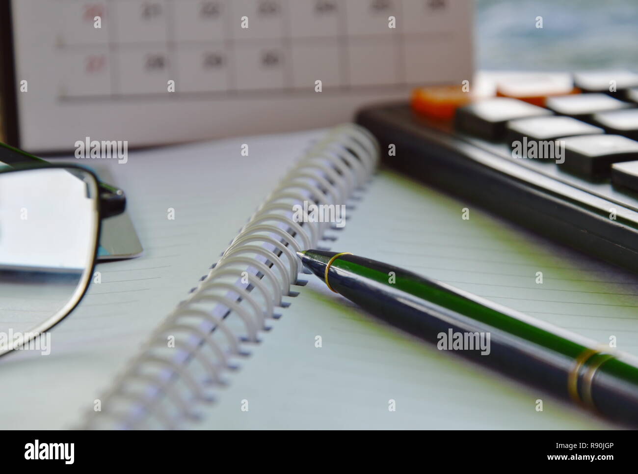 pen and calculator on the book Stock Photo - Alamy