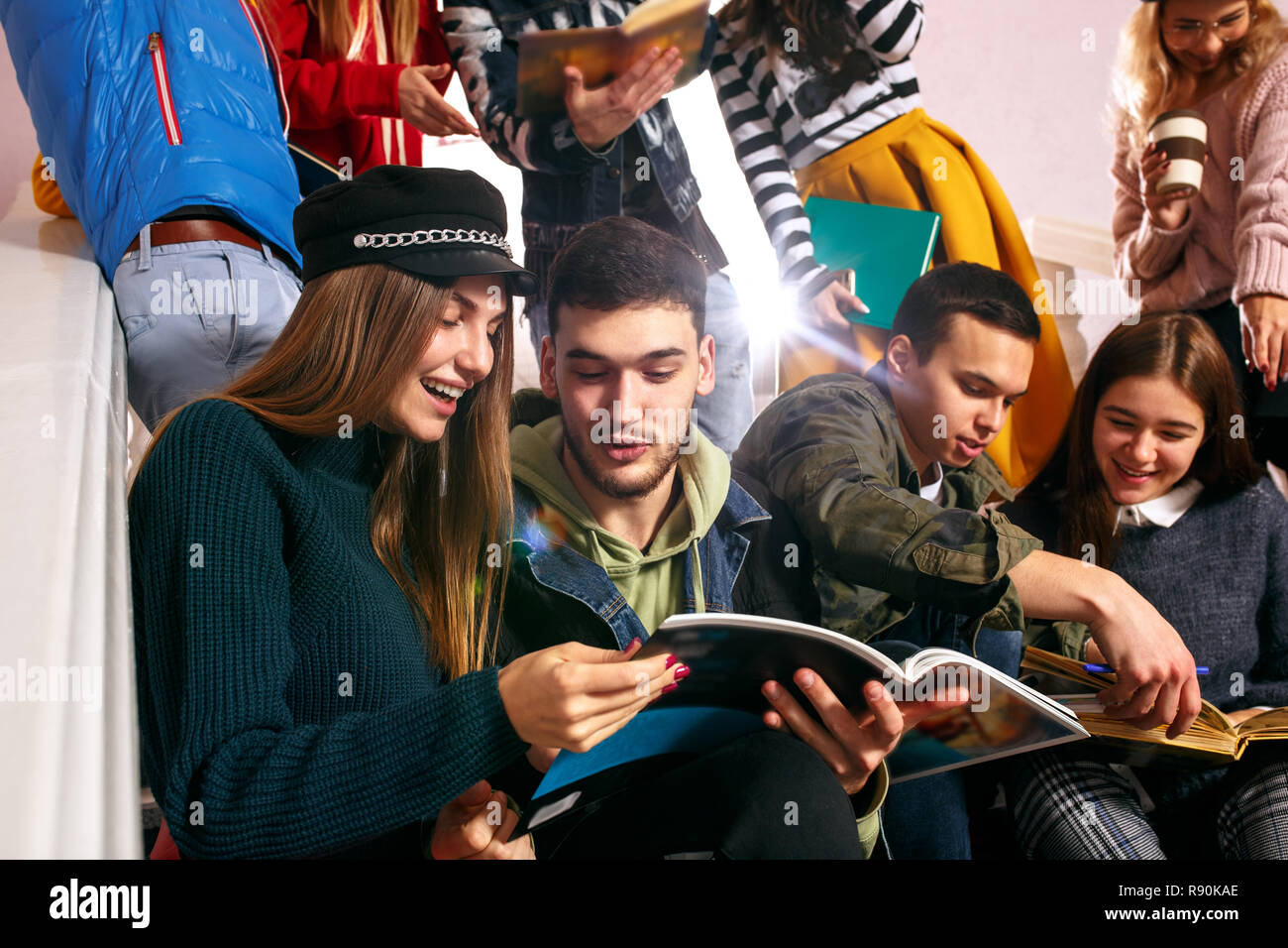The group of cheerful students sitting in a lecture hall before lesson ...