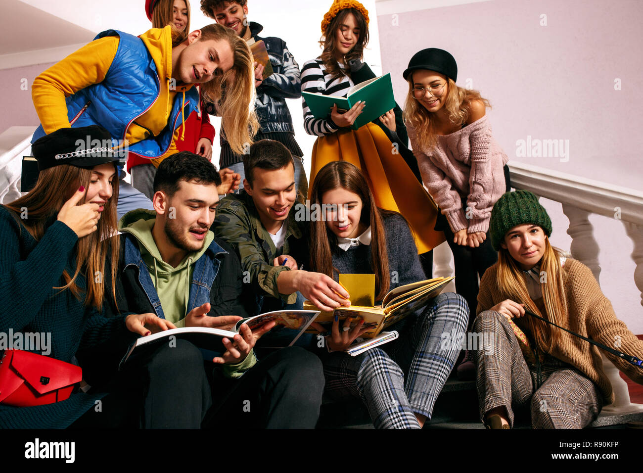 The group of cheerful students sitting in a lecture hall before lesson ...