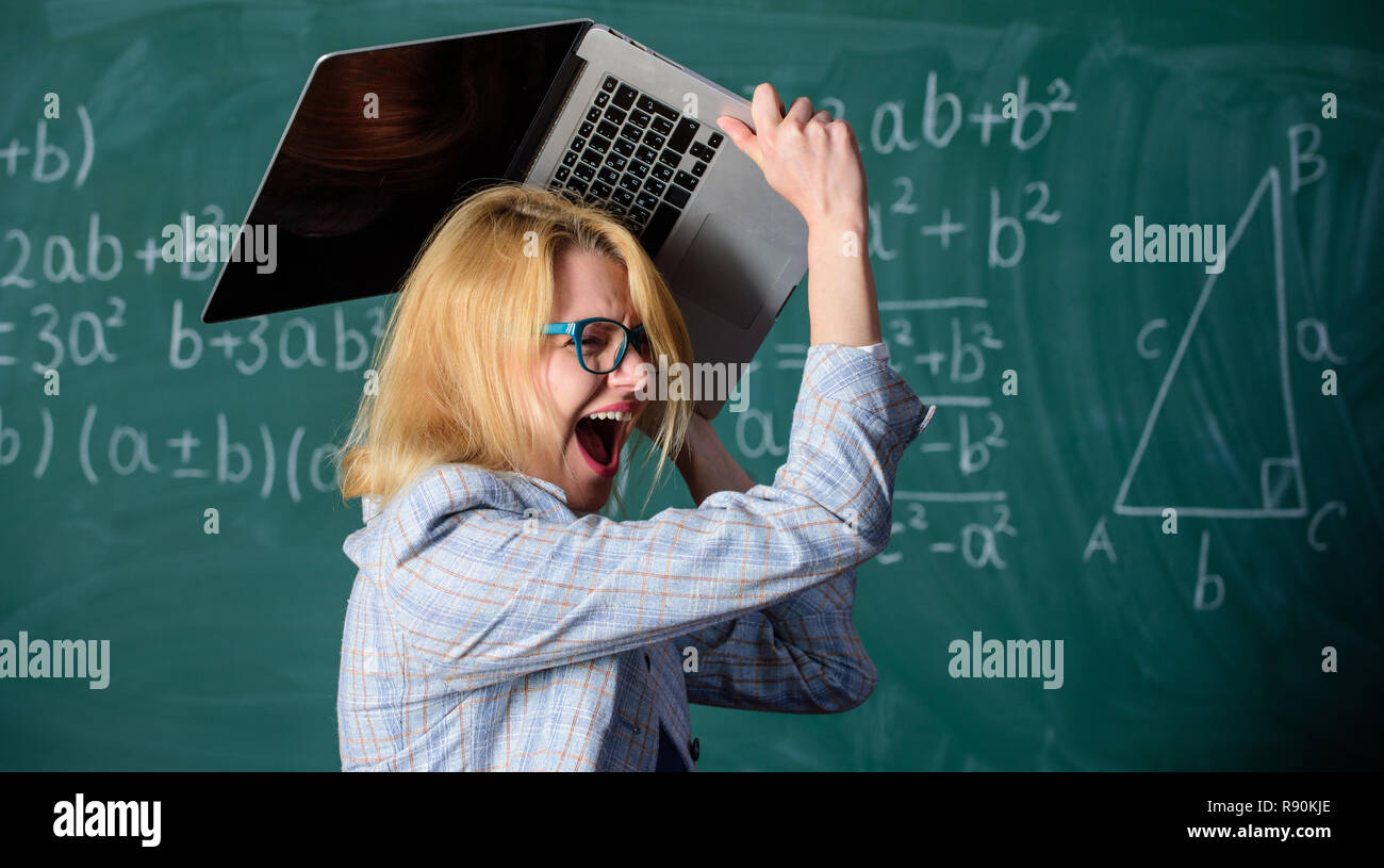 Overstrain of the nervous system. Teacher woman raising laptop above ...