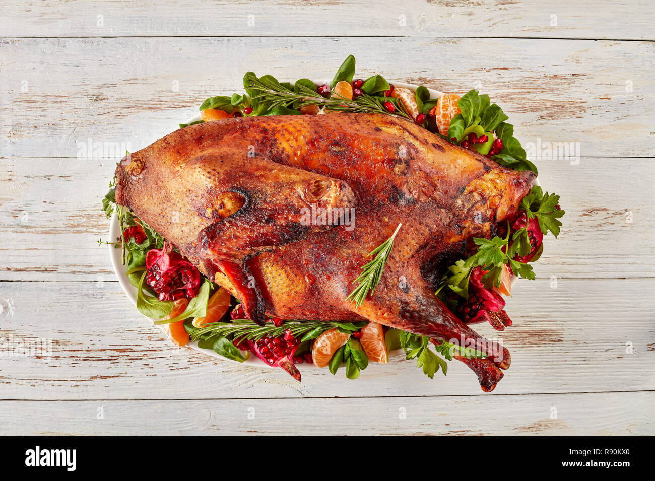 overhead view of a whole roasted free-range turkey on a white oval ...