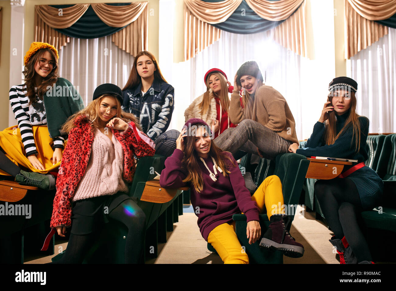The group of cheerful students sitting in a lecture hall before lesson ...