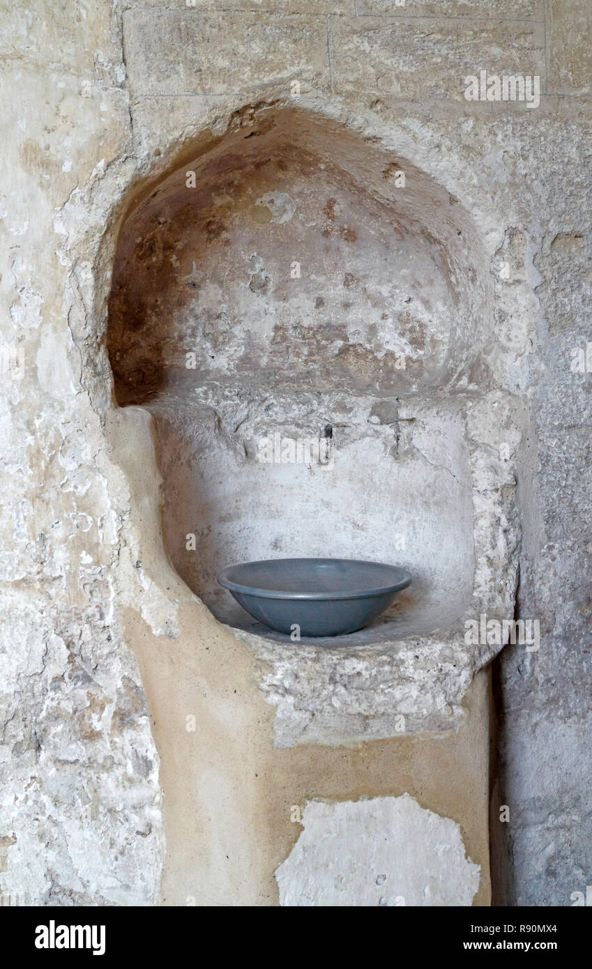 A stoup for holy water at the entrance to the Priory Church of St Mary ...