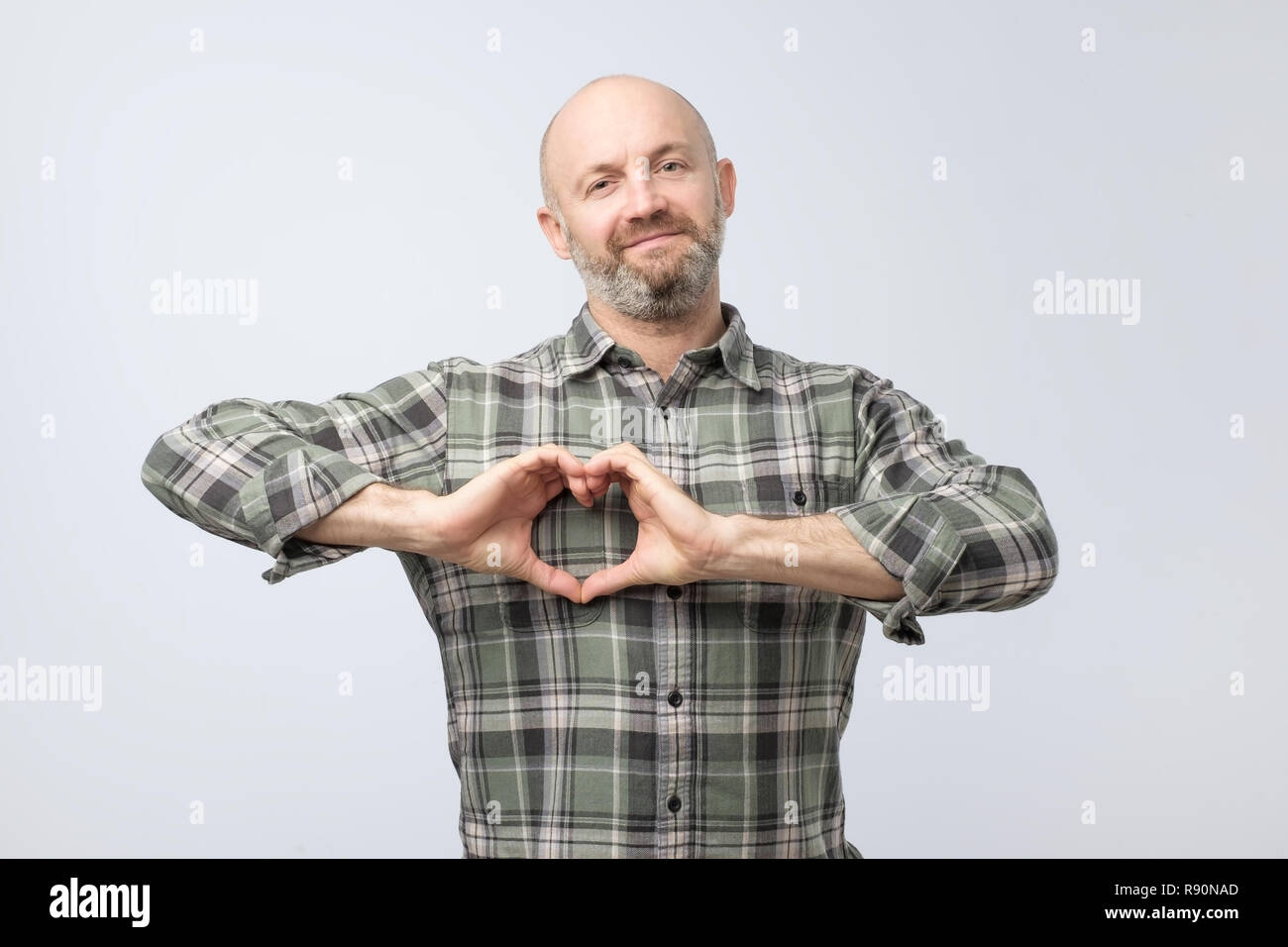 Charming attractive european man, holding hands in heart gesture Stock ...