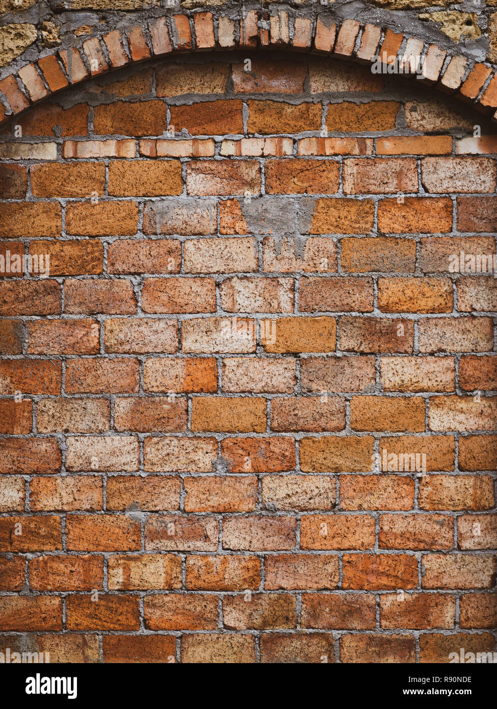 Old red brick wall with an arch Stock Photo - Alamy