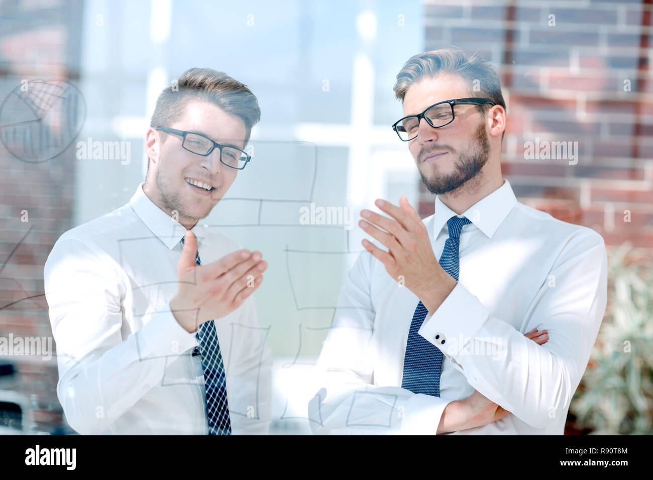 close up.two employees talking standing in the office Stock Photo - Alamy