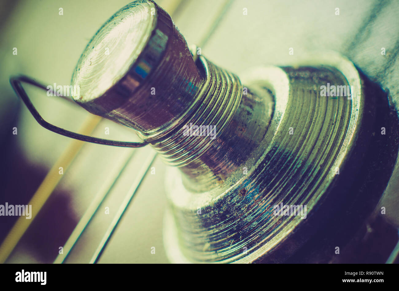 guitar peg with metal string macro Stock Photo - Alamy