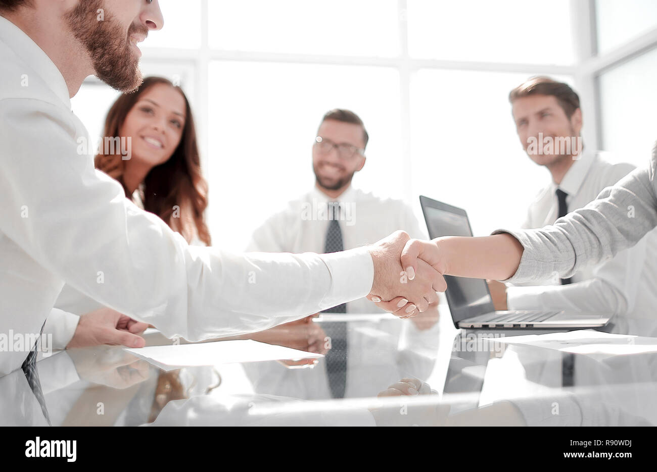 handshake of a businessman and business woman over a Desk Stock Photo ...