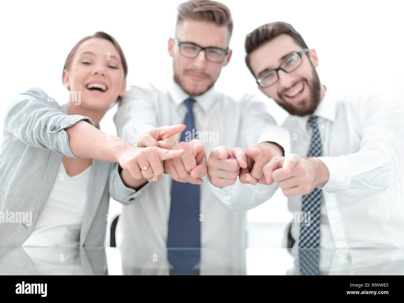 close up.a smiling business team pointing at you Stock Photo - Alamy