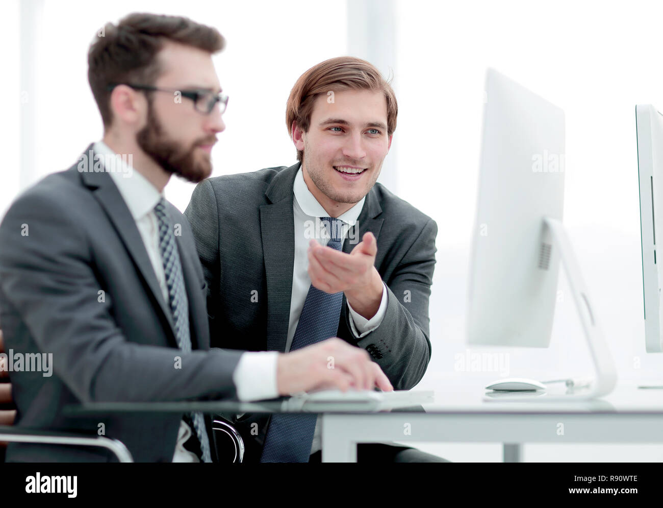 colleagues are discussing new data, sitting at a Desk Stock Photo - Alamy