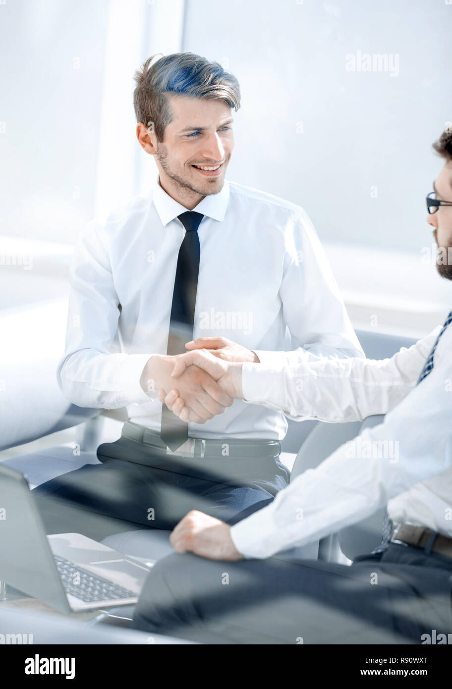 successful employees shaking hands sitting at the Desk Stock Photo - Alamy