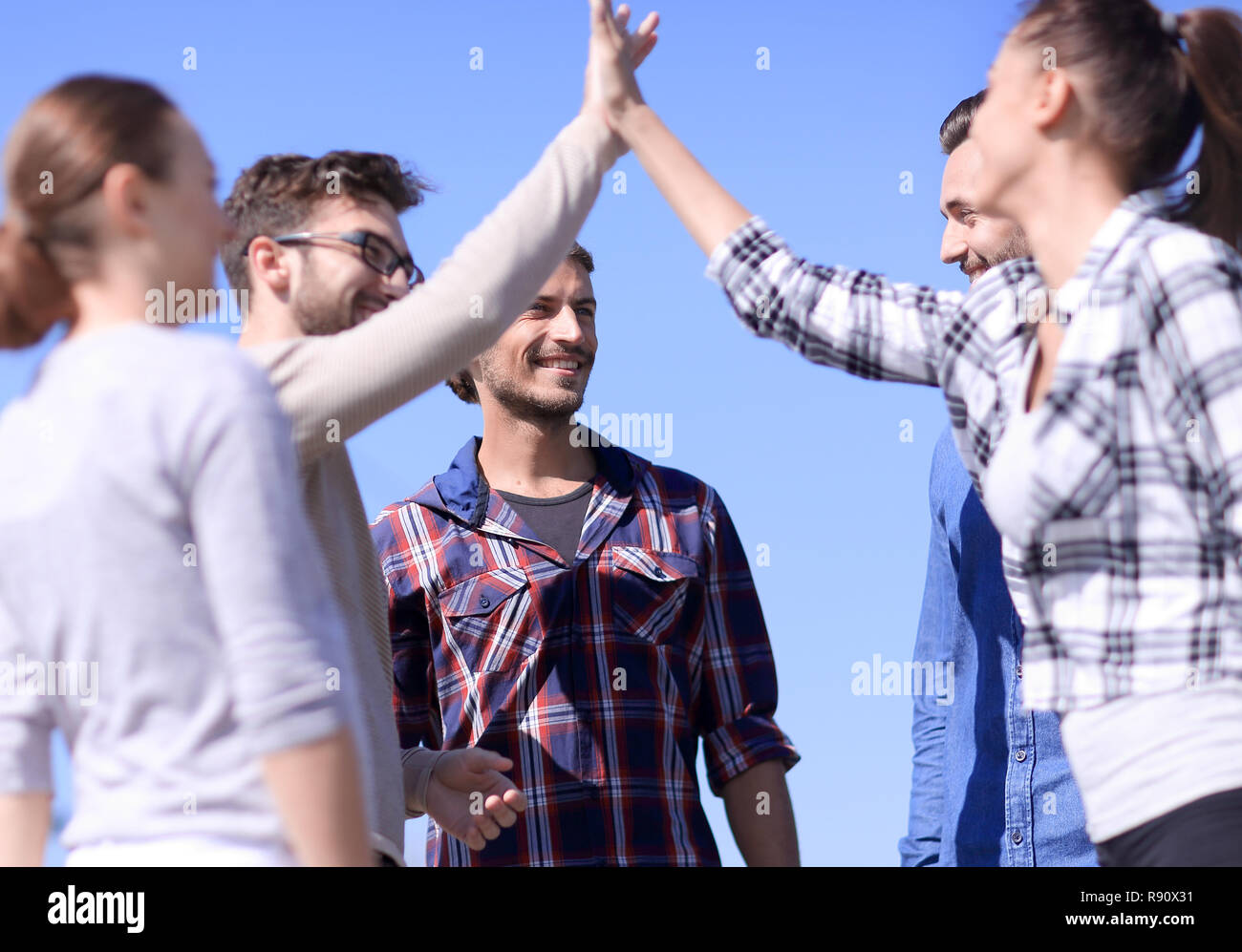 friends greet each other, giving a high five Stock Photo - Alamy