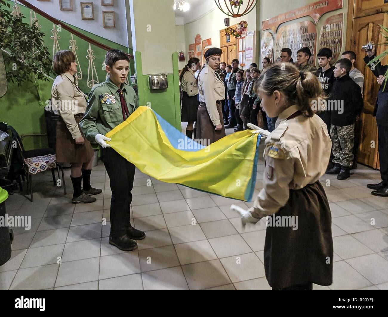 Members of the Boys and Girls Scouts fold the Ukraine flag during a ...