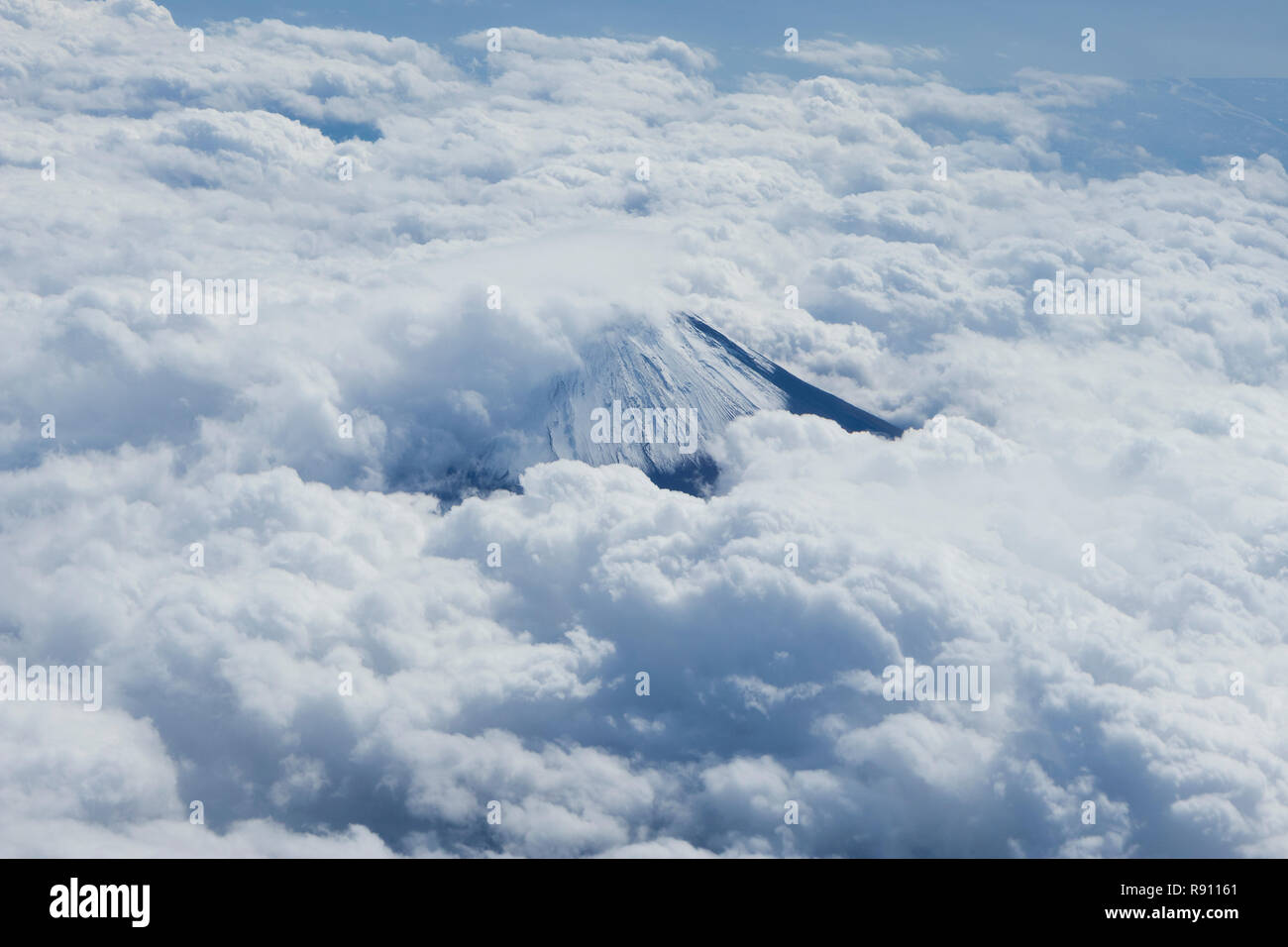 Top of Mount Fuji seen from the air between the clouds Stock Photo - Alamy