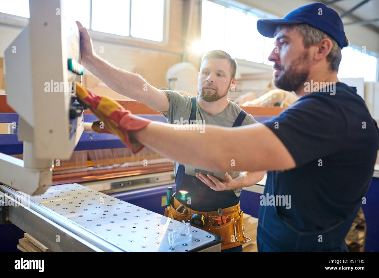 Operators pushing buttons on control panel Stock Photo - Alamy