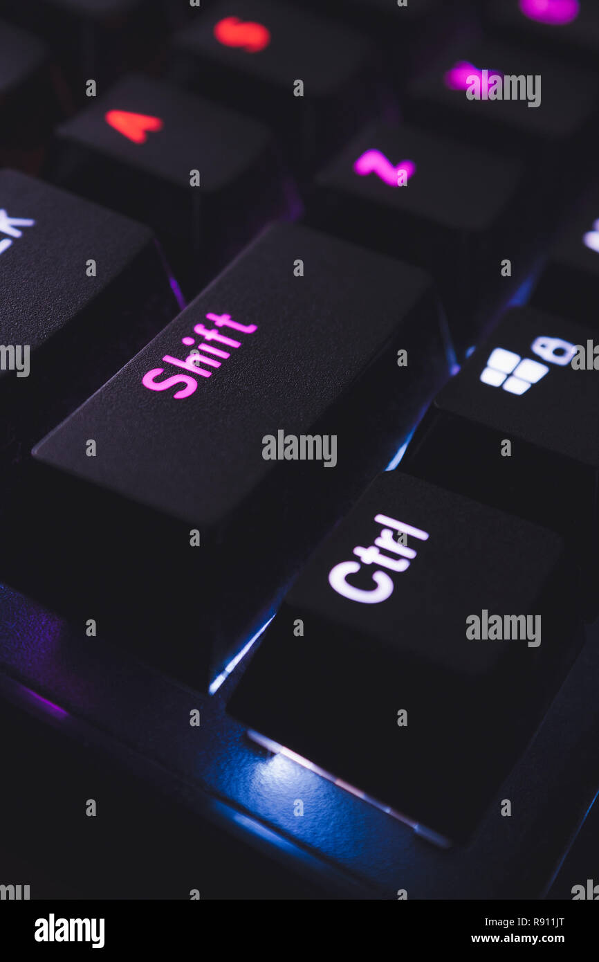 Black keyboard keys with colorful lights underneath, close up Stock ...