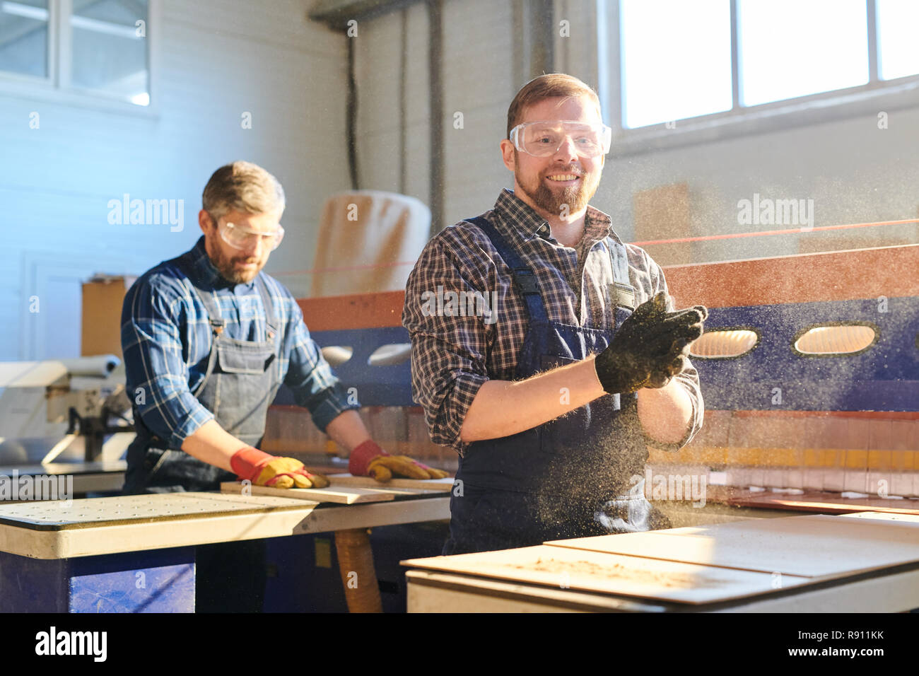 Excited man working at furniture factory Stock Photo - Alamy