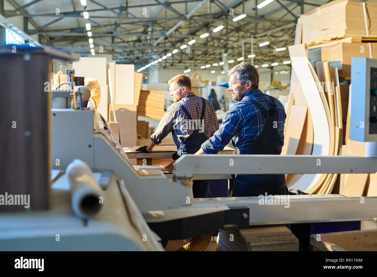 Industrial workers in assembly shop Stock Photo - Alamy