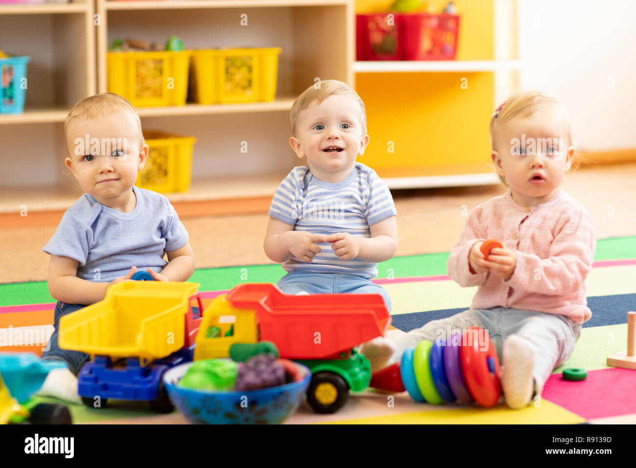 Babies playing together in the kindergarten, nursery or daycare Stock ...
