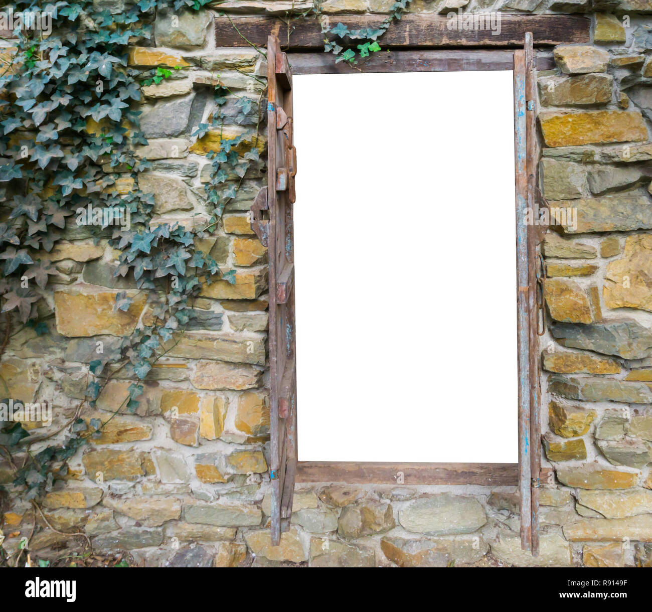 old medieval looking wooden window framework in a brick wall with ivy ...