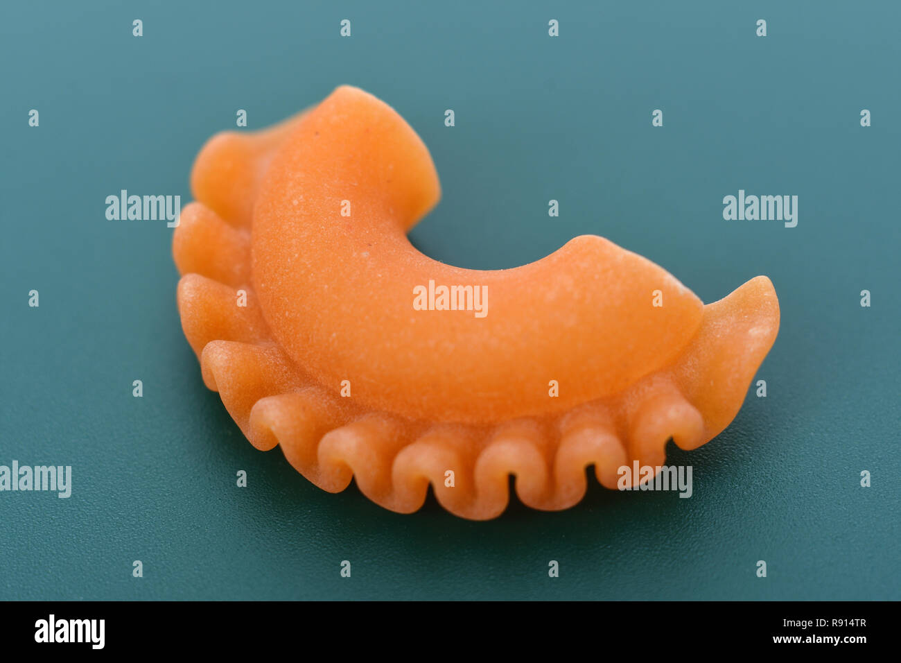 Pasta creste di gallo on green background Stock Photo - Alamy