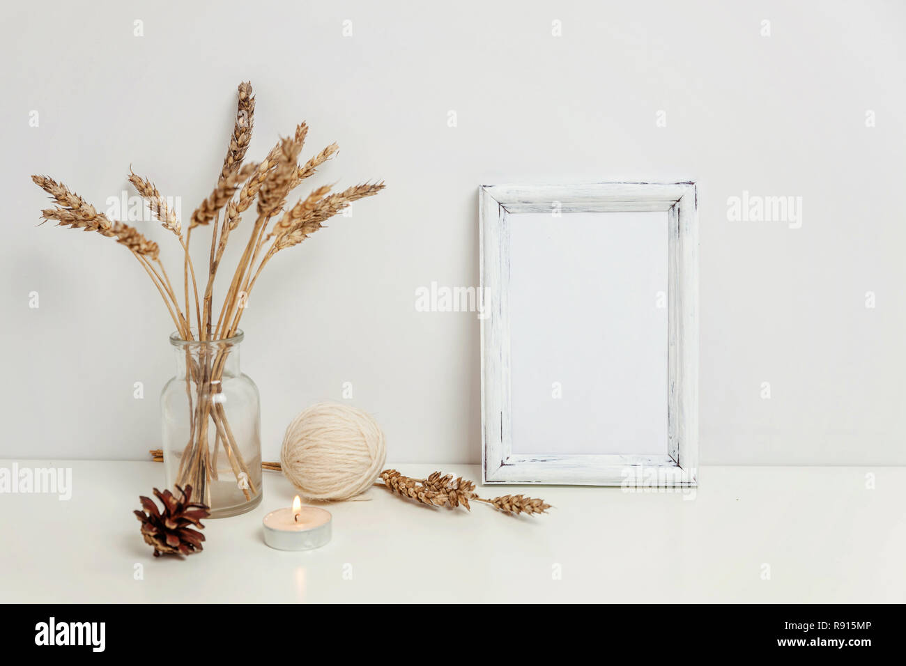Vertical frame mockup with wild rye bouquet in glass vase near white ...