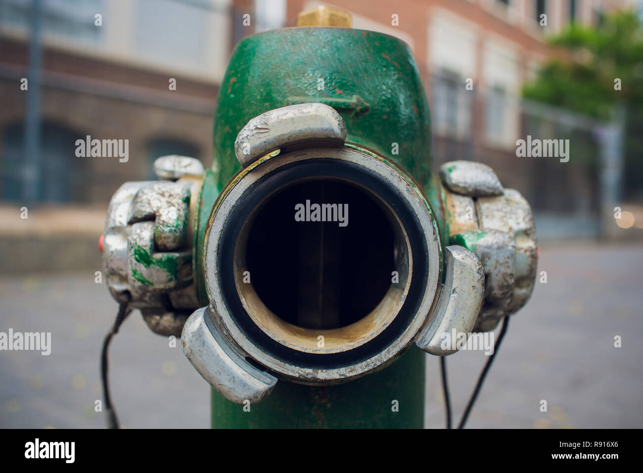 green fire hydrant in a city street for firefighters Stock Photo - Alamy