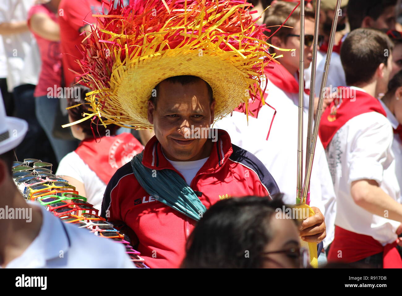 Man in straw hat selling sunglasses at Los Caballos Del Vino in ...
