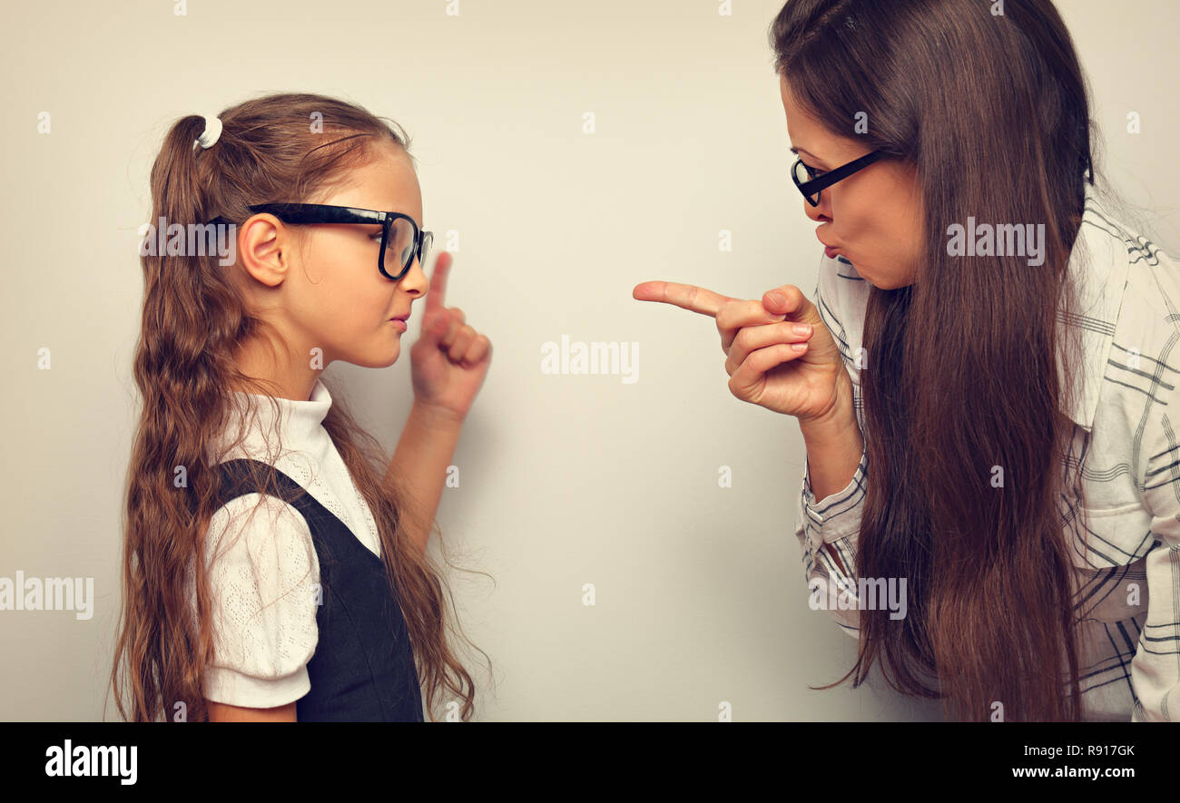 Angry beautiful woman in eye glasses scolding her pupil daughter and ...